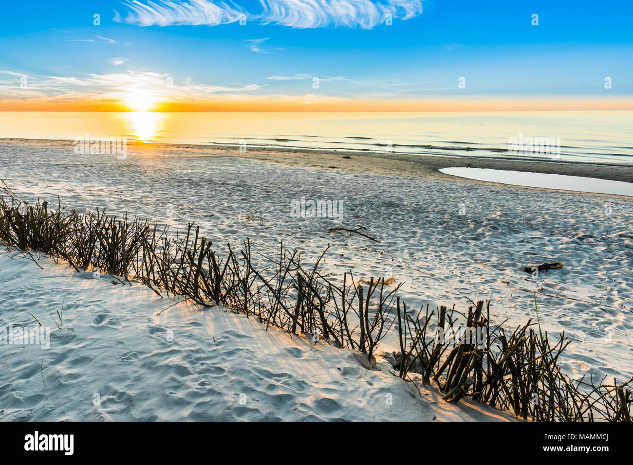 Sandy beach and sunset sky with golden sun shining on white sand Stock ...