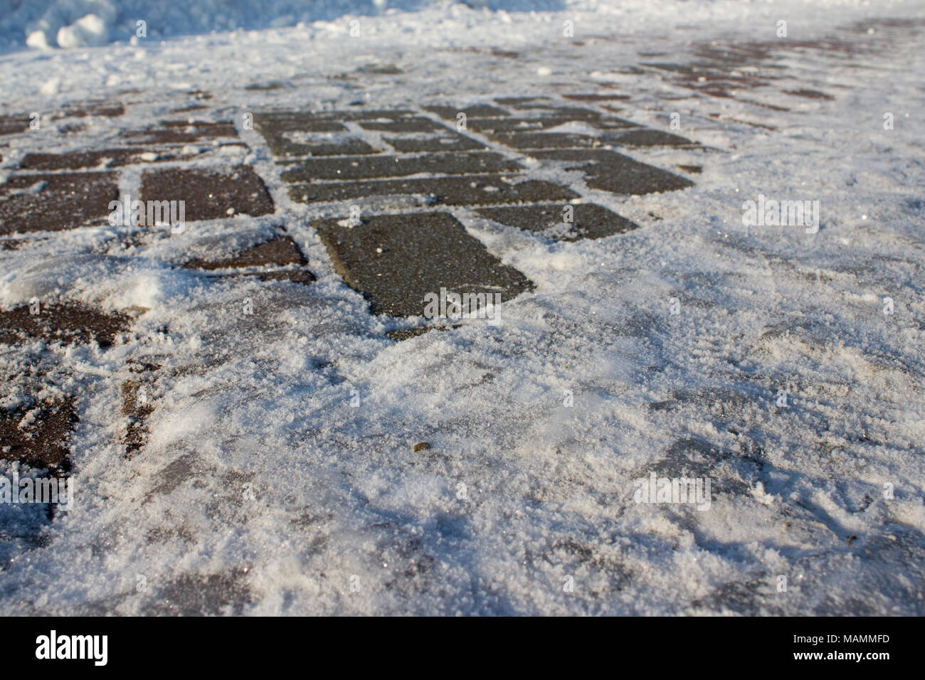 Ice on the pavement slab Stock Photo - Alamy