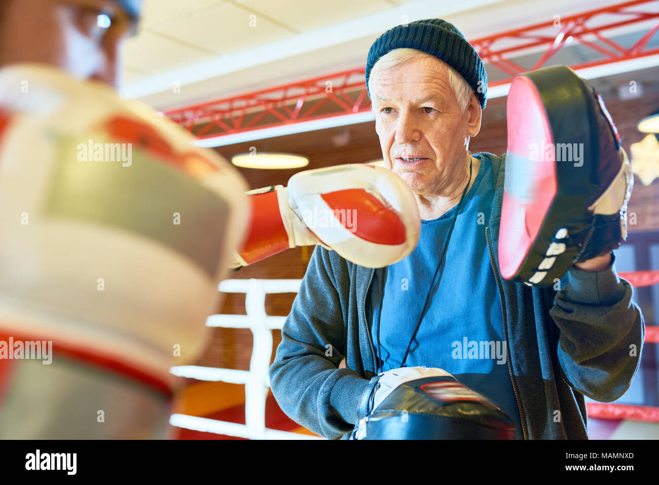 Boxer training coach in ring hi-res stock photography and images - Alamy
