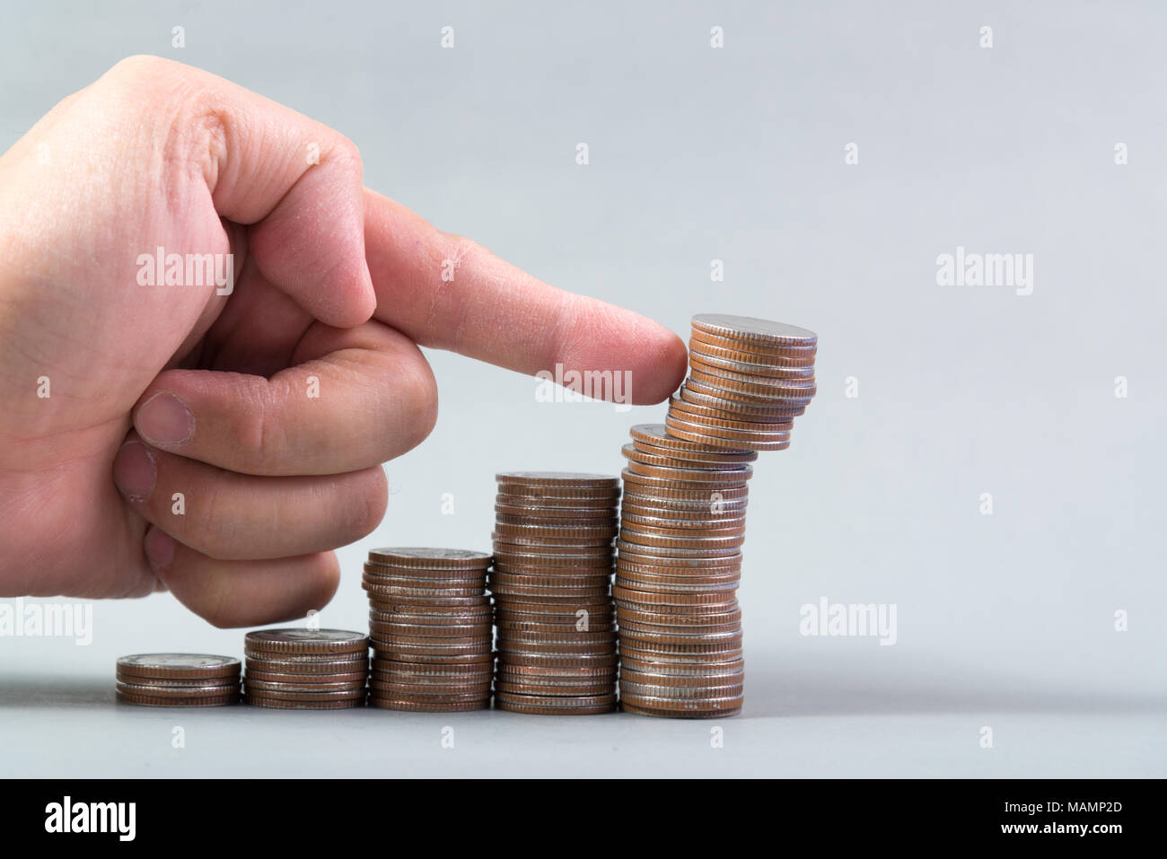 Finger pushing a pile of coins, column of coins falls , business crisis ...