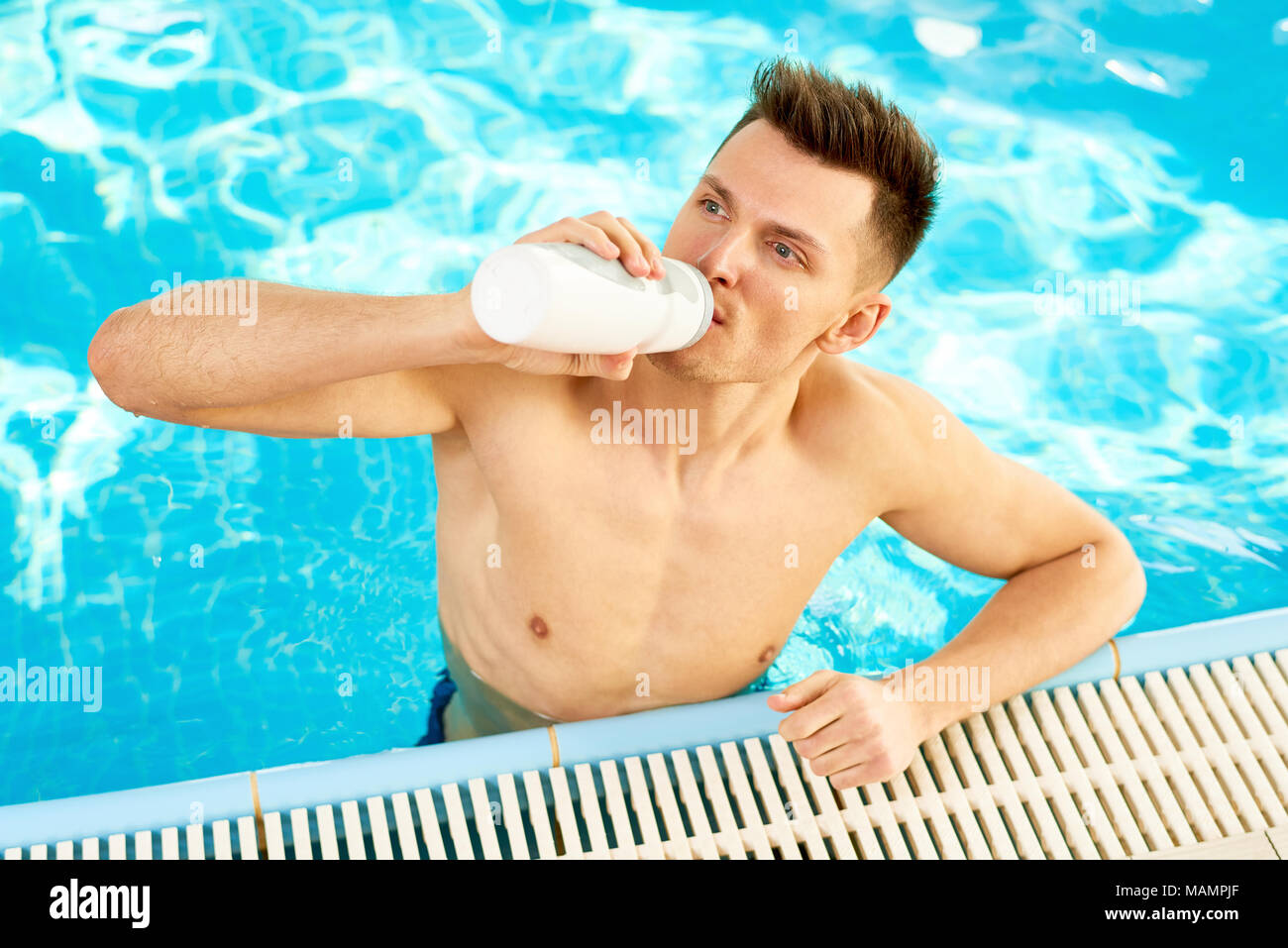Athlete Drinking Water in Pool Stock Photo - Alamy