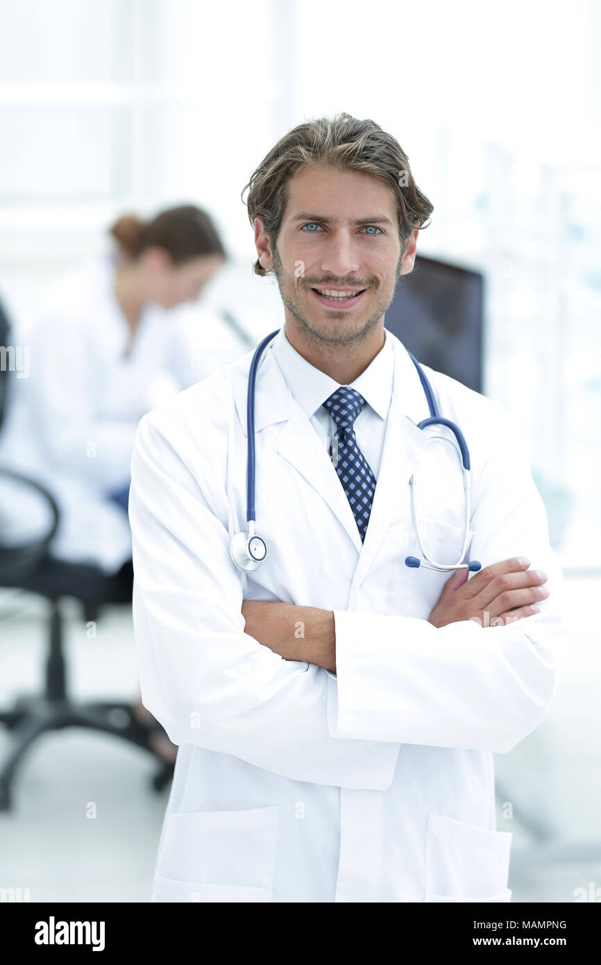 Handsome male doctor smiling with arms crossed on chest portrait Stock ...
