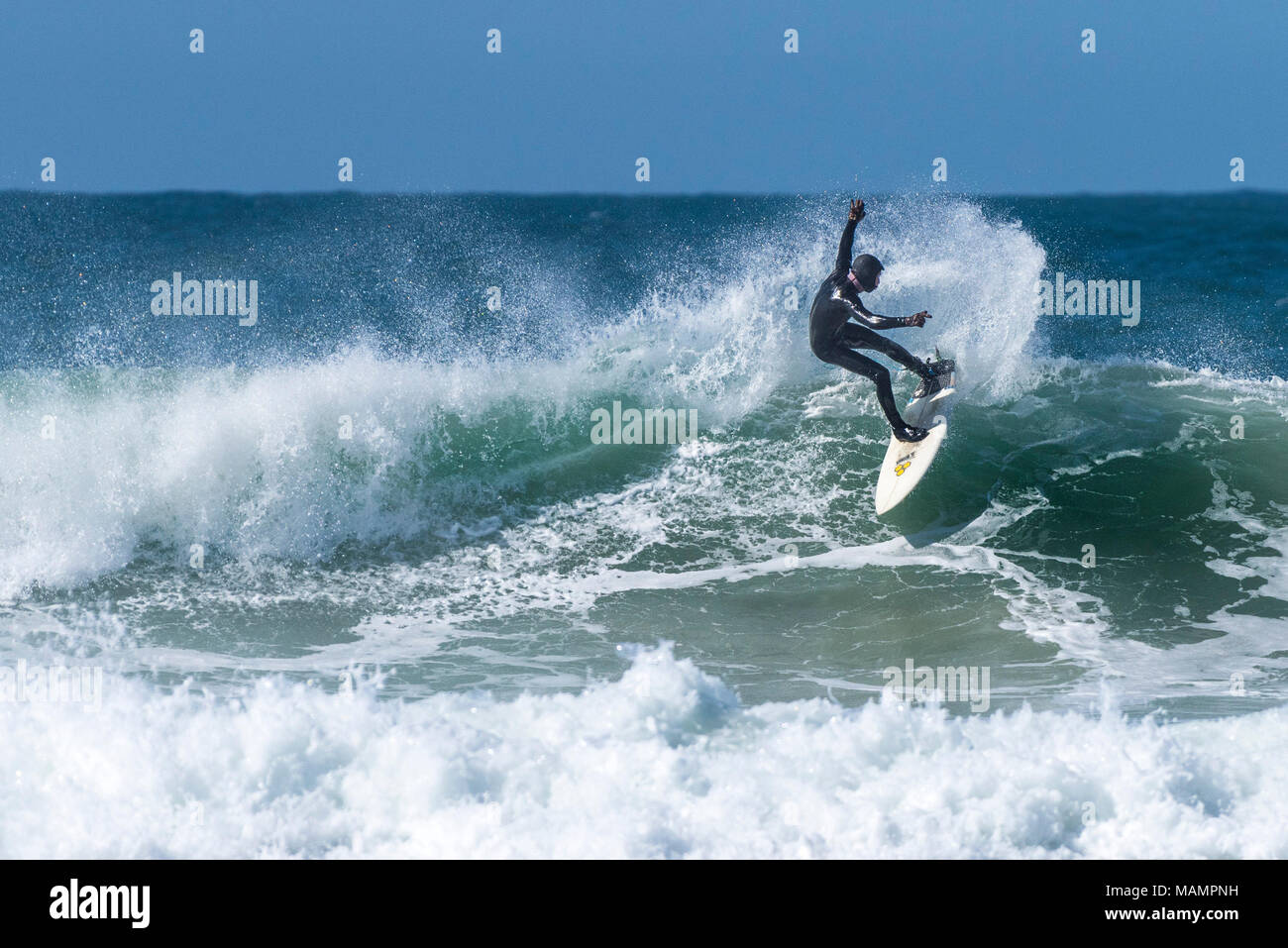 Surfing UK - a surfer riding a wave at Fistral in Newquay Cornwall ...