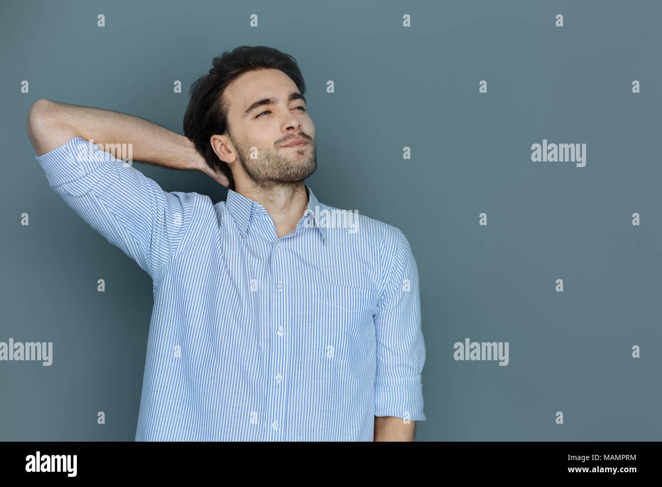 Positive cheerful man touching his head Stock Photo - Alamy