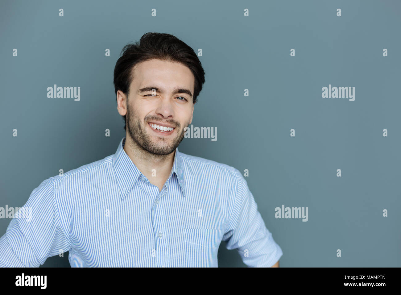 Cheerful positive man winking Stock Photo - Alamy Cheerful positive man winking Stock Photo - Alamy