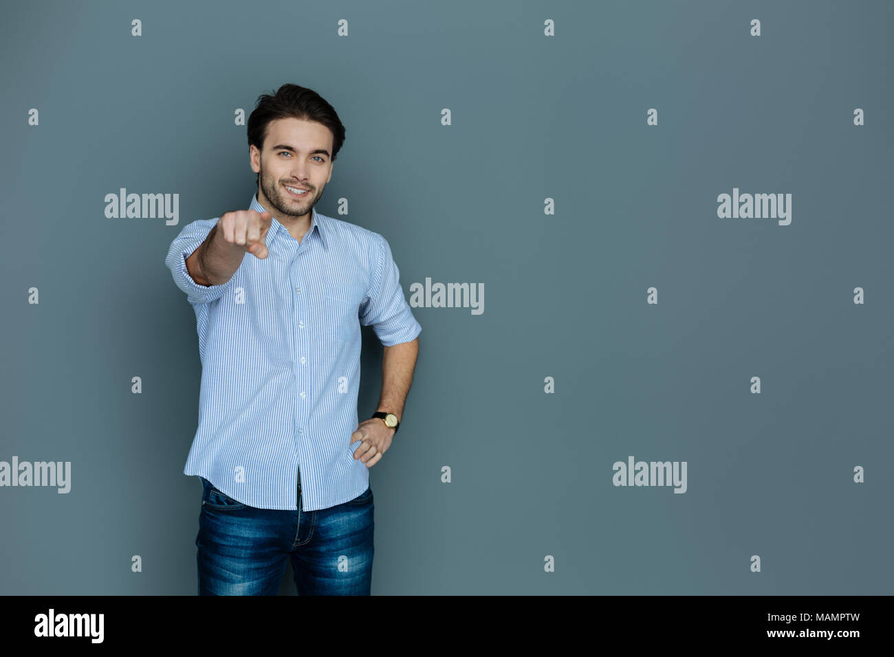 Happy handsome man pointing with his hand Stock Photo - Alamy