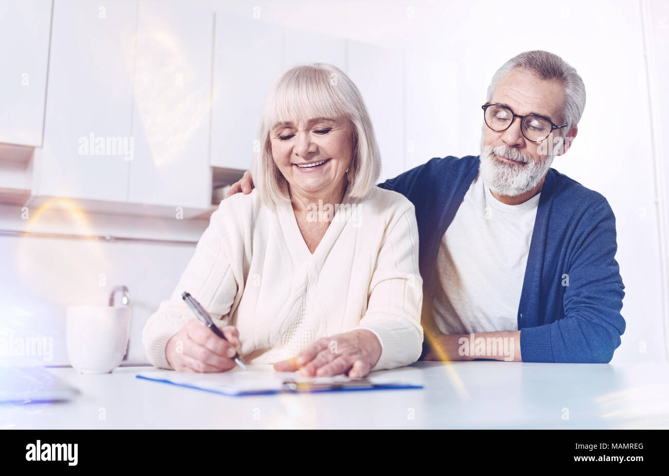 Elderly man signing papers hi-res stock photography and images - Alamy
