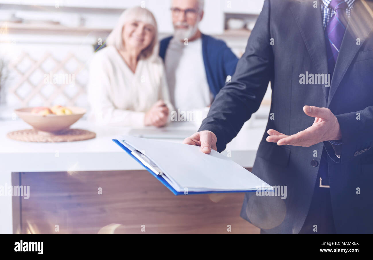 Professional insurance agent holding papers Stock Photo - Alamy