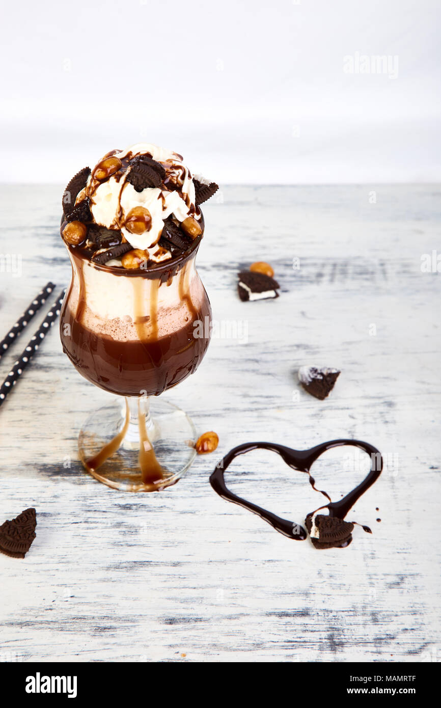 Extreme milkshake with chocolate, cookies and sweets. Crazy freakshake ...