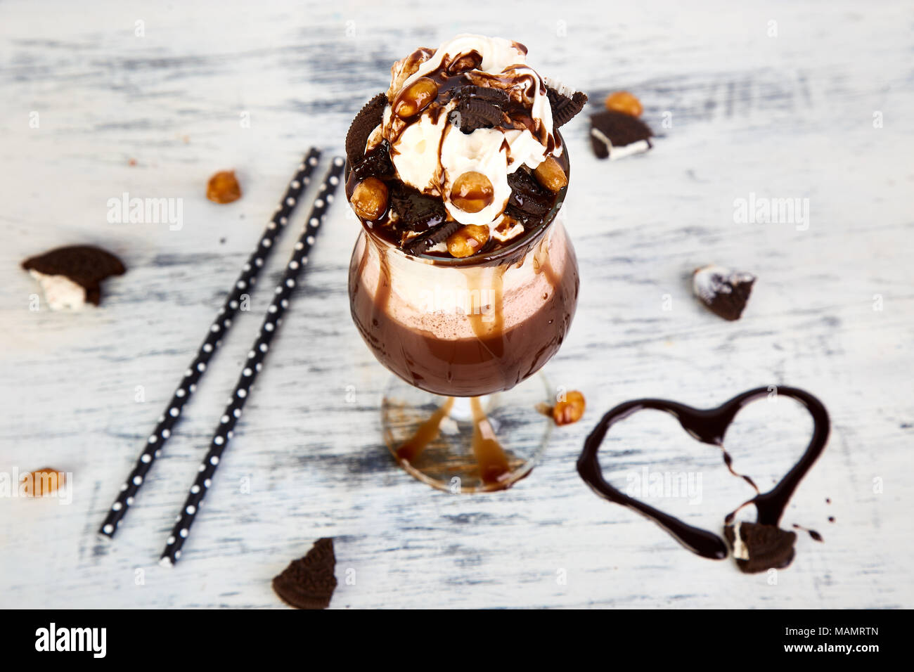 Extreme milkshake with chocolate, cookies and sweets. Crazy freakshake ...