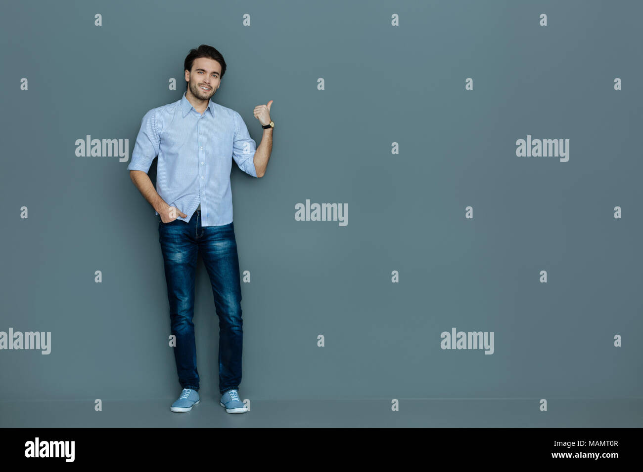Cheerful positive man pointing with his finger Stock Photo - Alamy