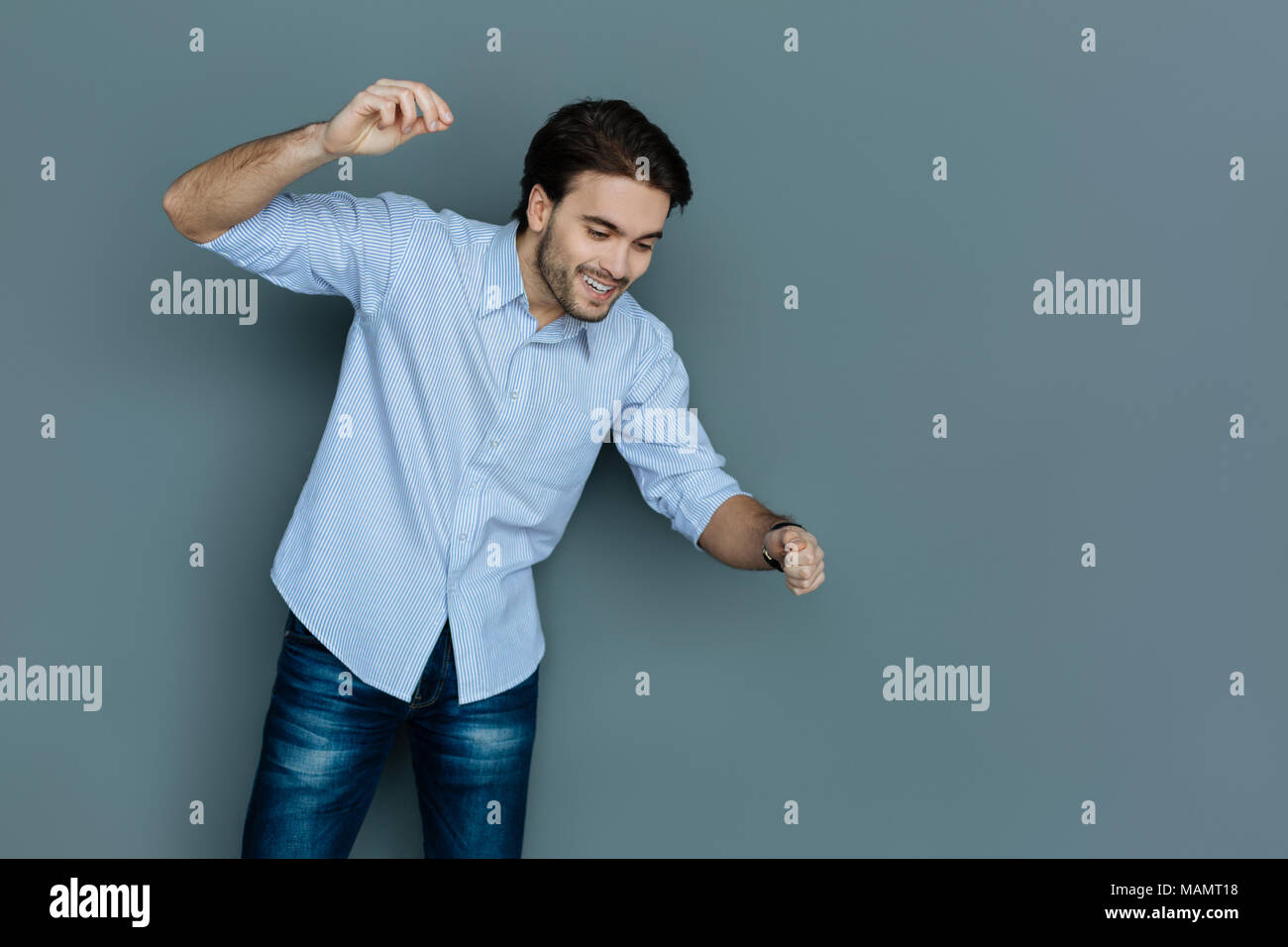 Cheerful happy man looking down Stock Photo - Alamy