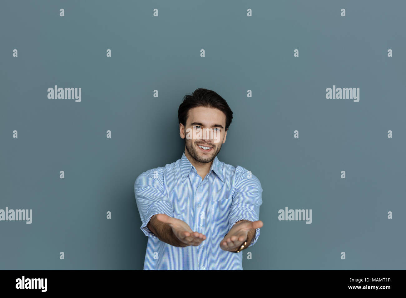 Positive handsome man showing you his hands Stock Photo - Alamy