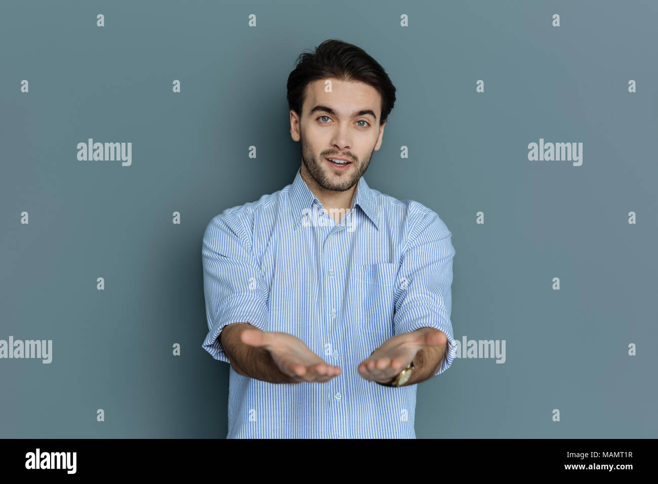 Positive delighted man stretching hi-res stock photography and images ...