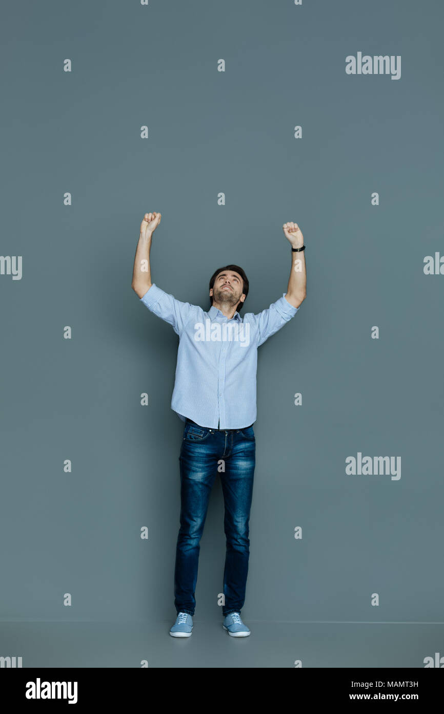 Positive joyful man looking up Stock Photo - Alamy