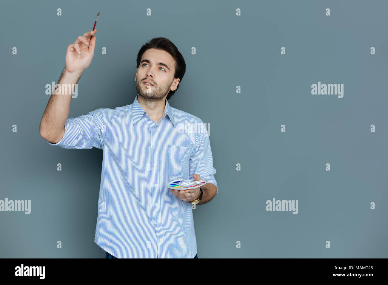 Nice creative man painting Stock Photo - Alamy