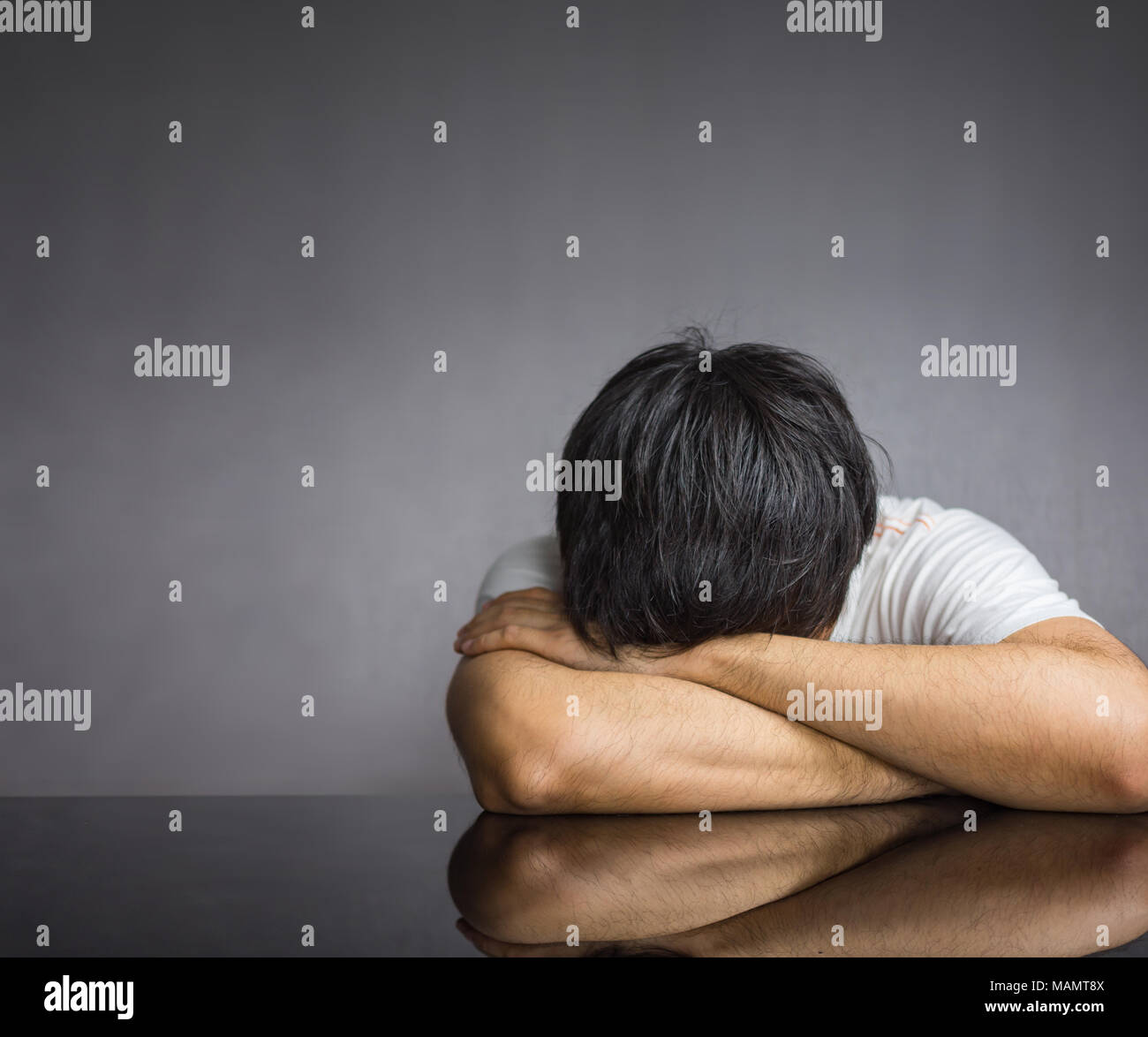Face against table on dark background Stock Photo - Alamy