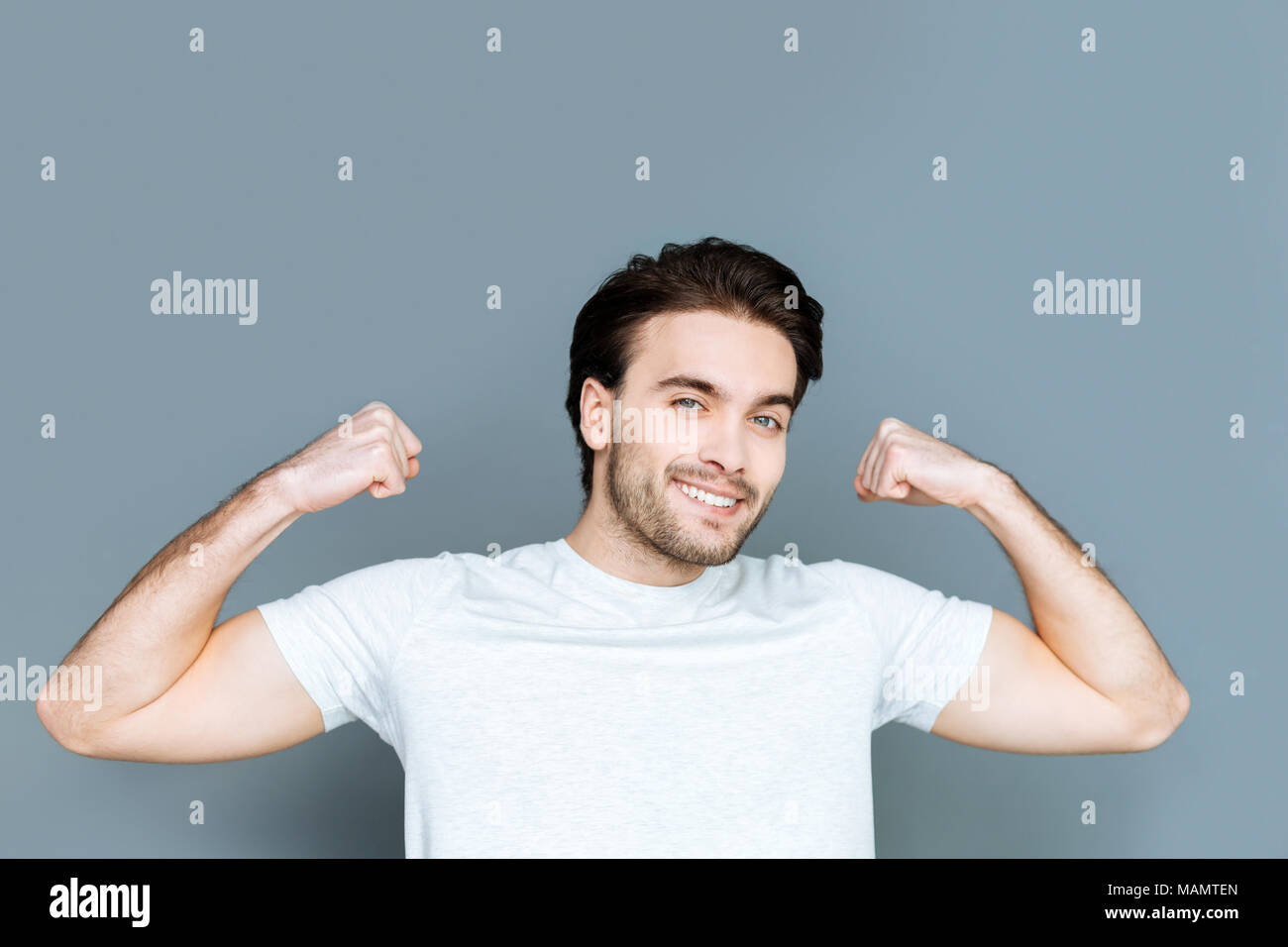 Joyful well built man showing his body Stock Photo - Alamy