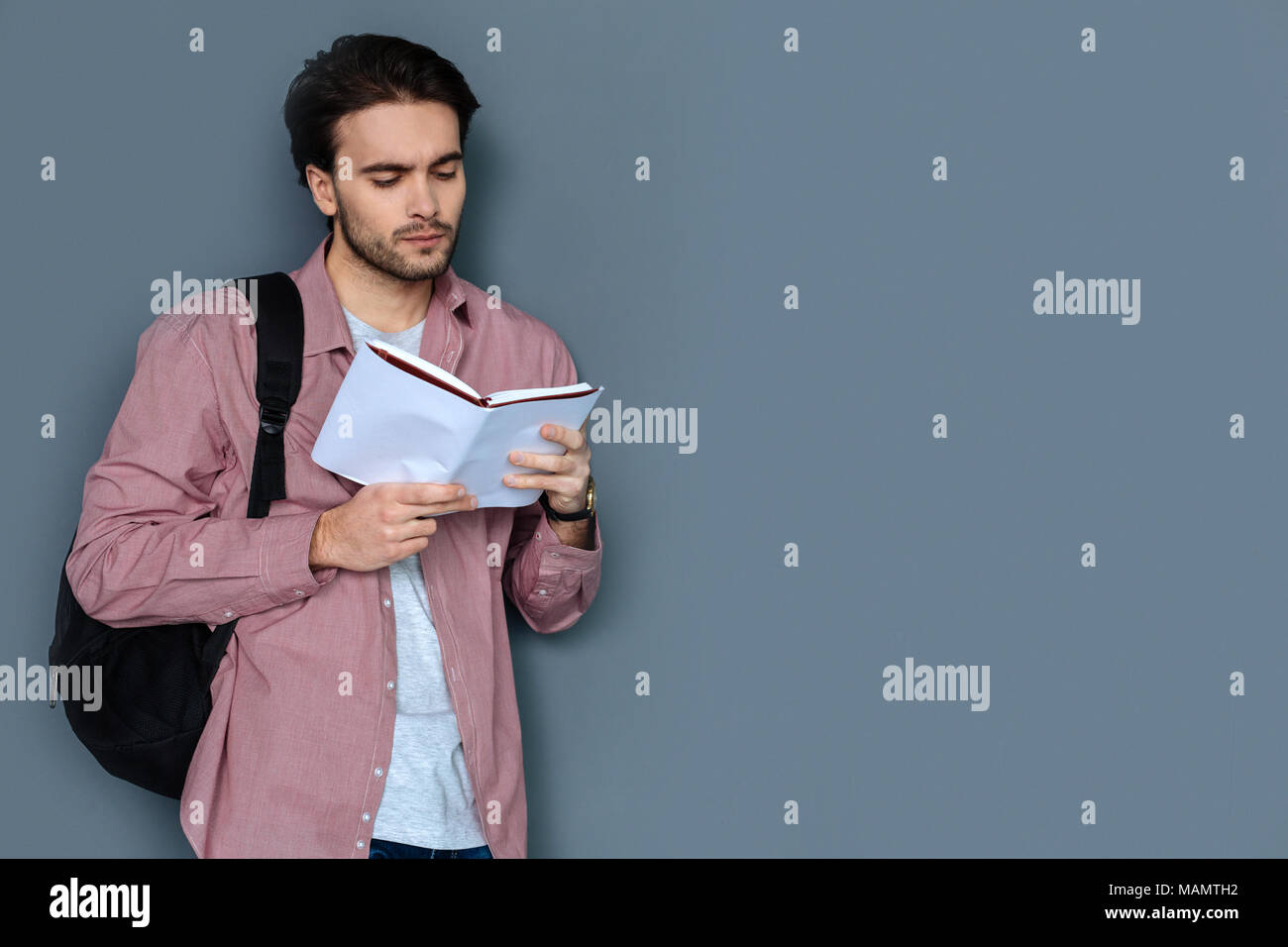 Smart nice man reading a book Stock Photo - Alamy