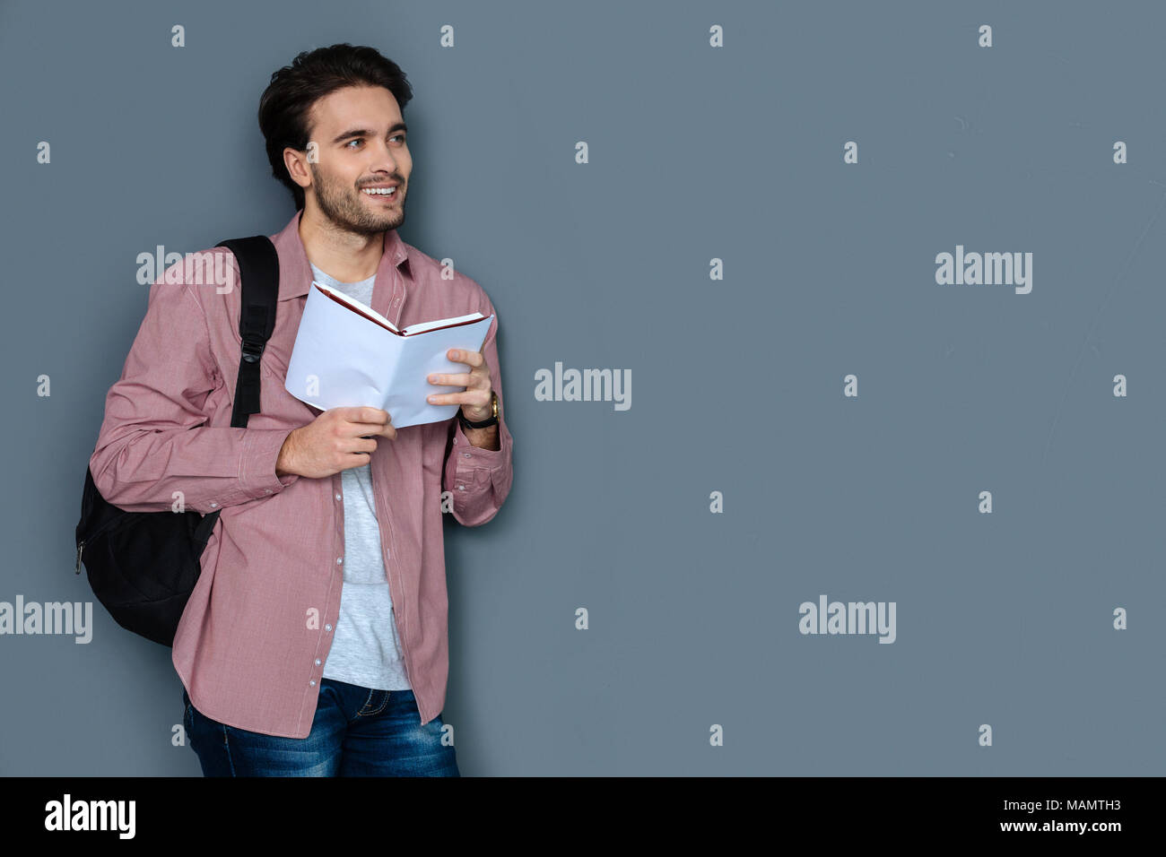 Cheerful male tourist reading a tour guide Stock Photo - Alamy