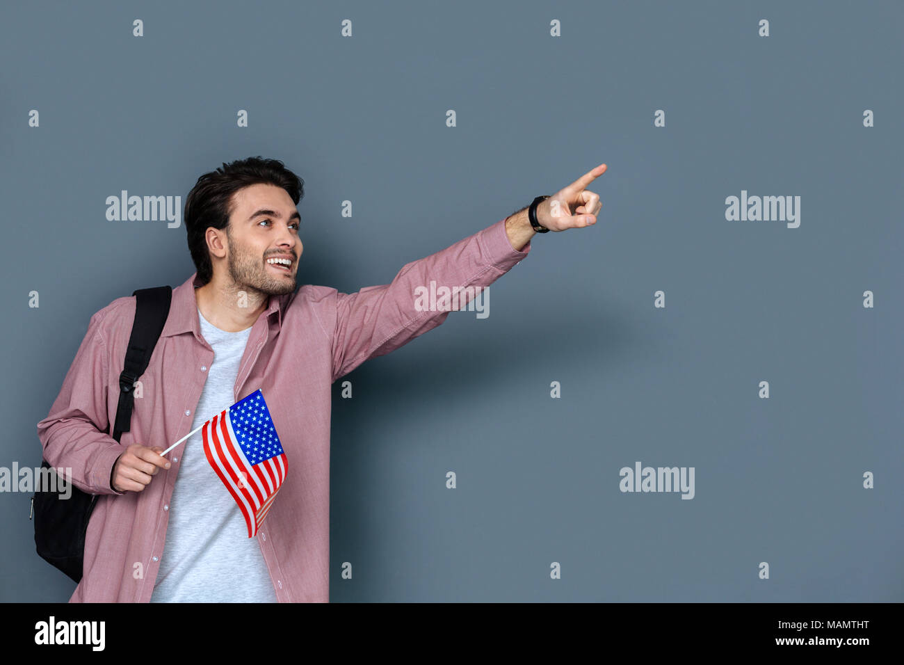 Delighted happy man pointing with his hand Stock Photo - Alamy