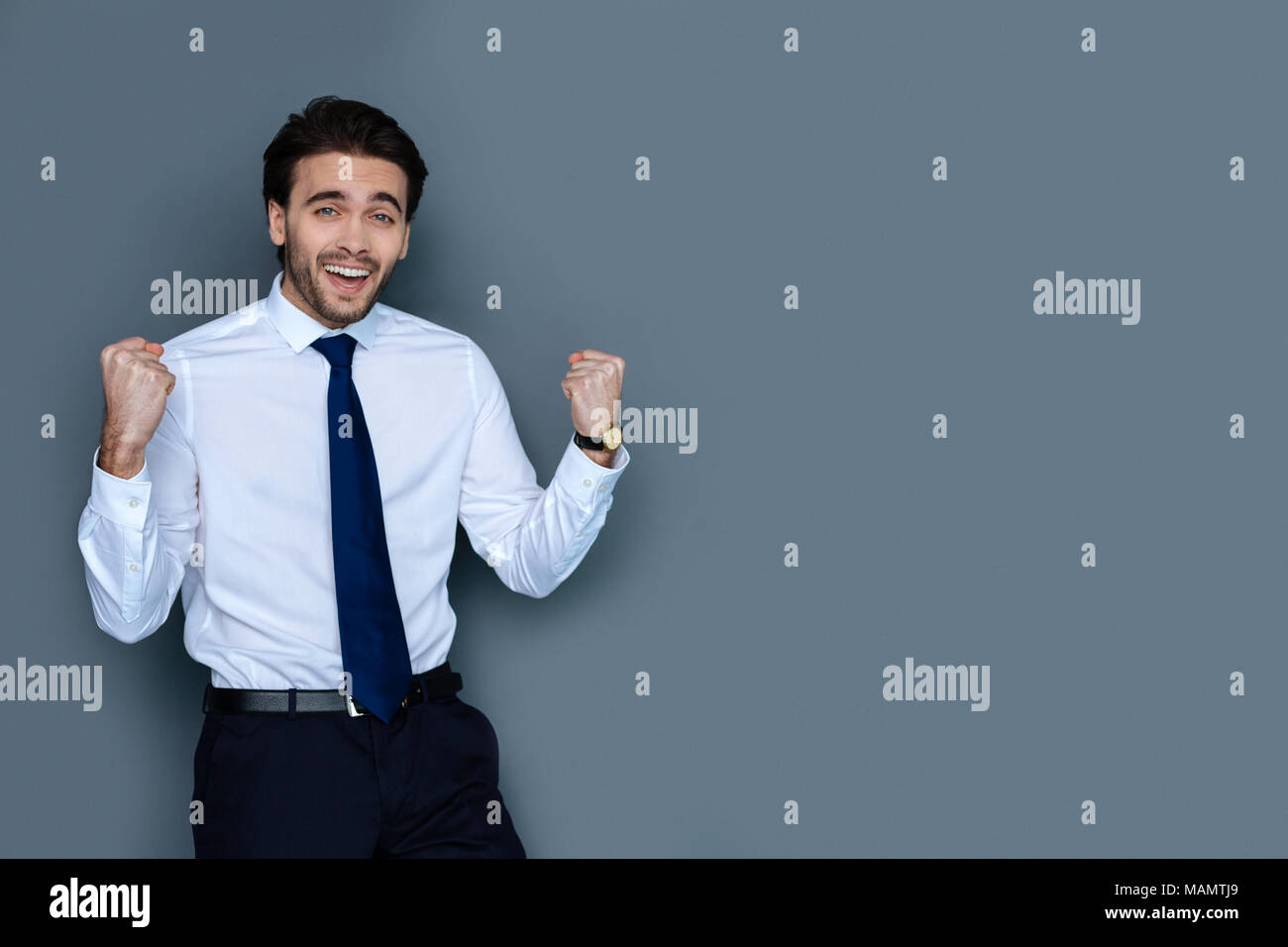 Joyful nice man celebrating his success Stock Photo - Alamy