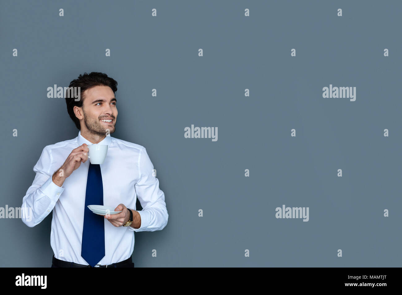 Joyful handsome man enjoying coffee Stock Photo - Alamy