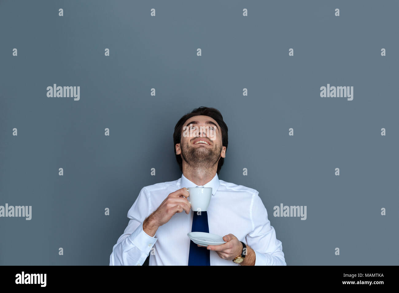 Happy delighted man enjoying his drink Stock Photo - Alamy