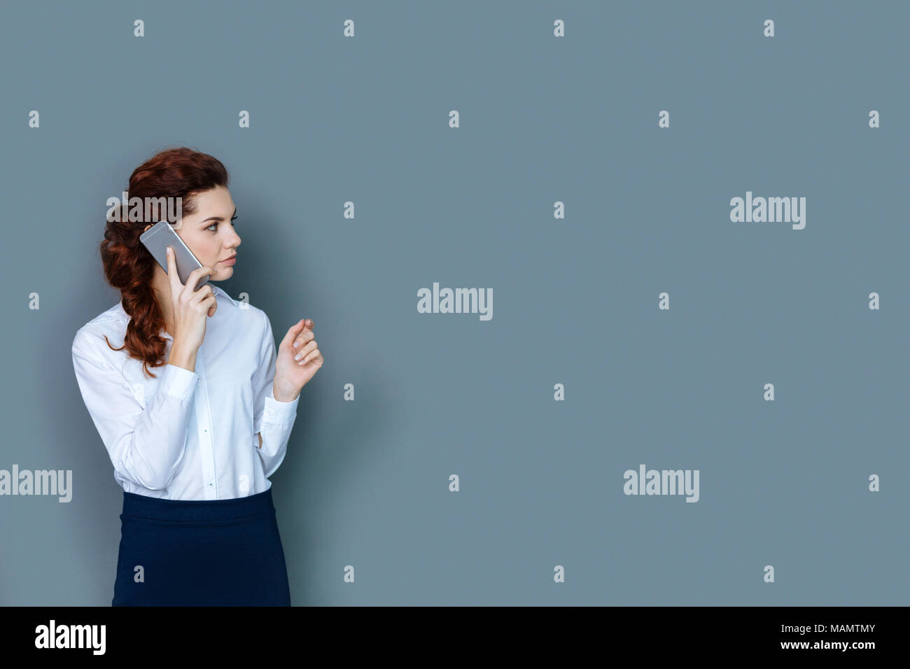 Serious confident businesswoman making a call Stock Photo - Alamy