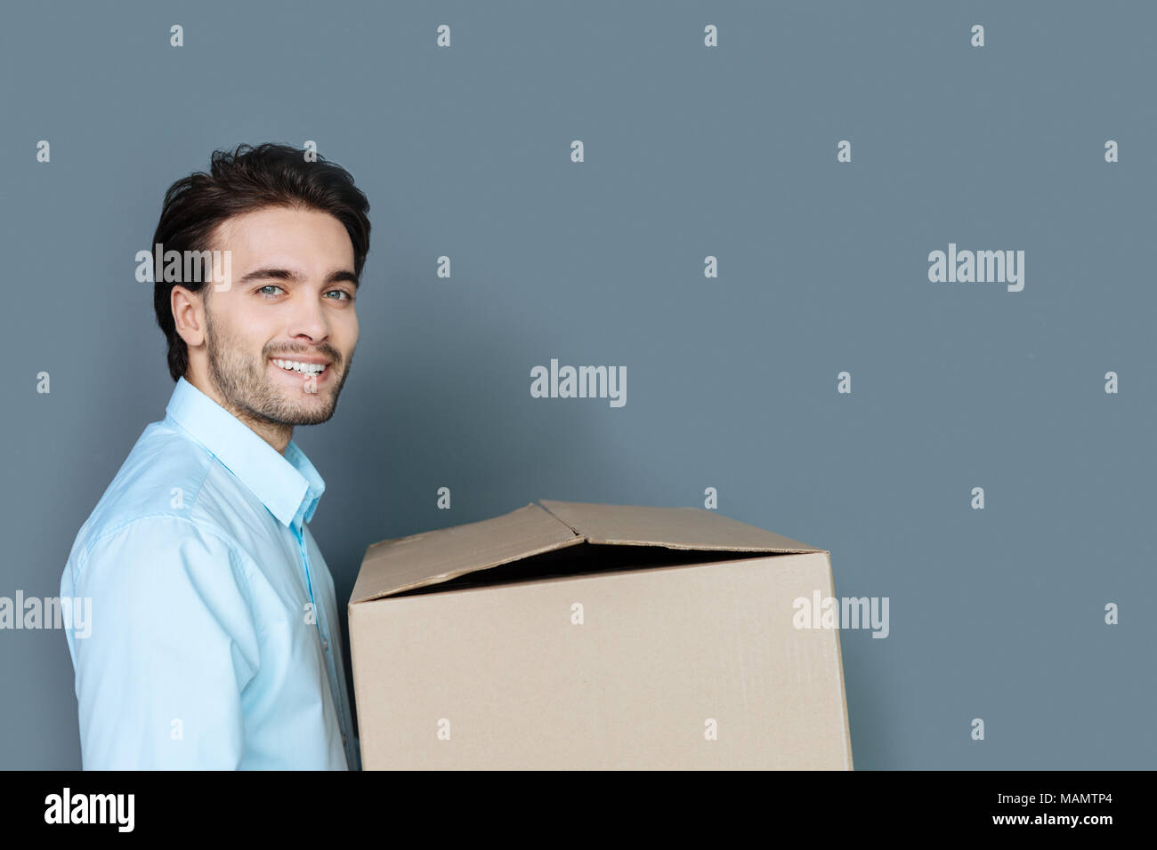 Cheerful happy man holding the box Stock Photo - Alamy