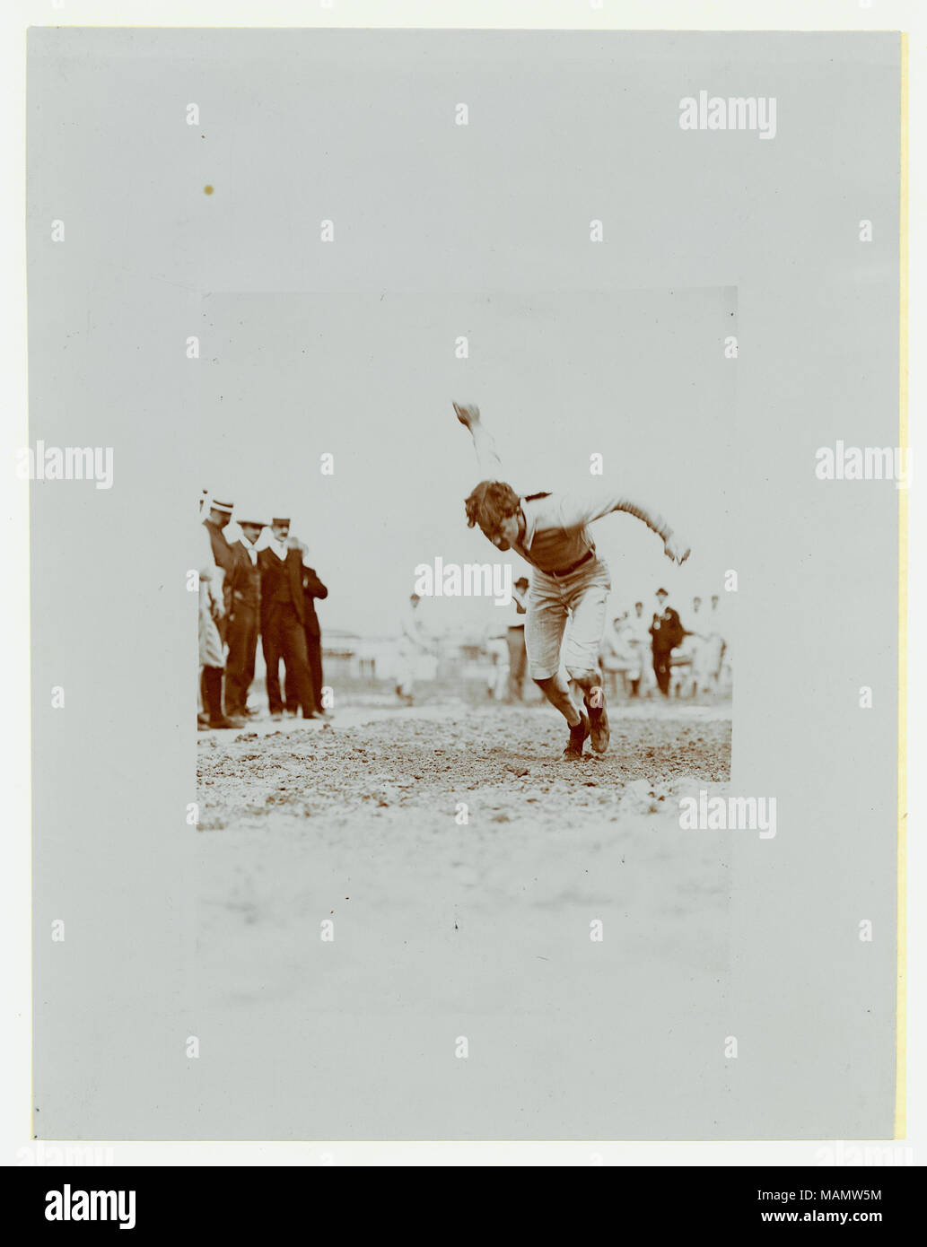 Vertical photograph of an athlete completing a broad jump, also known ...