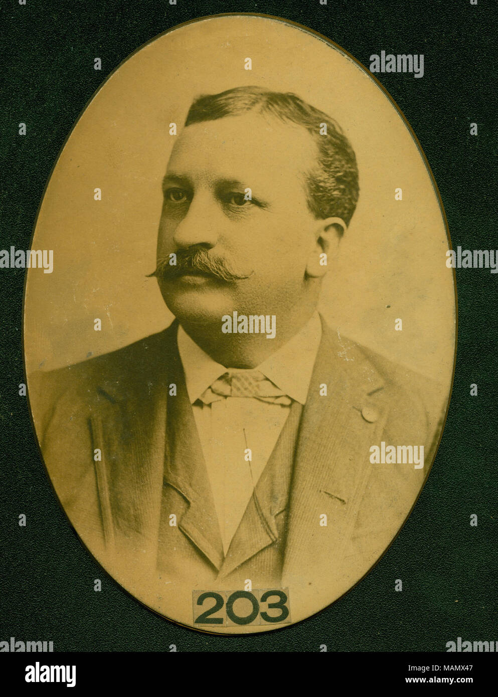 Formal bust portrait of E. A. Becker wearing a suit and bow tie, with ...