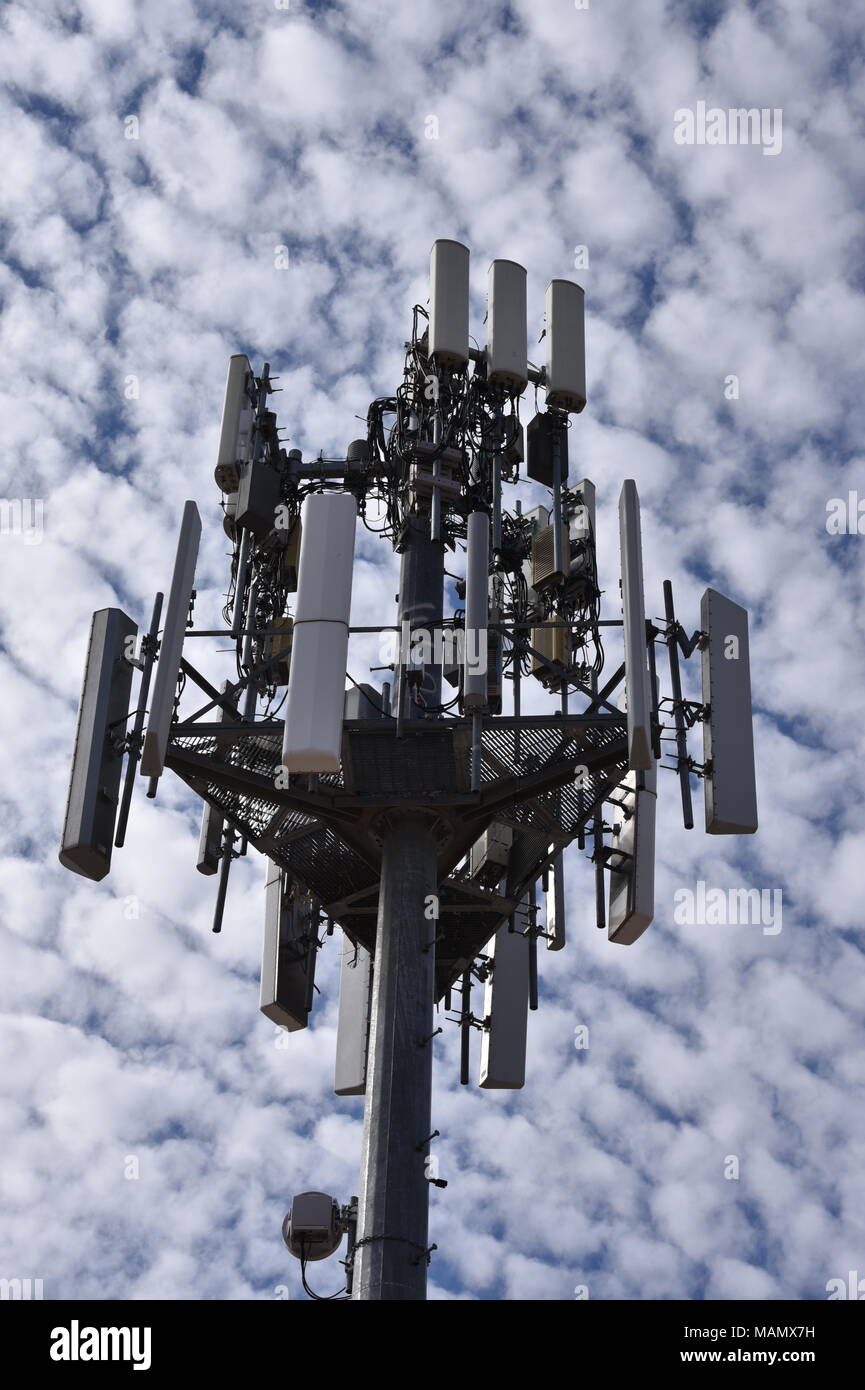 Cell phone tower against a blue sky and clouds Stock Photo - Alamy