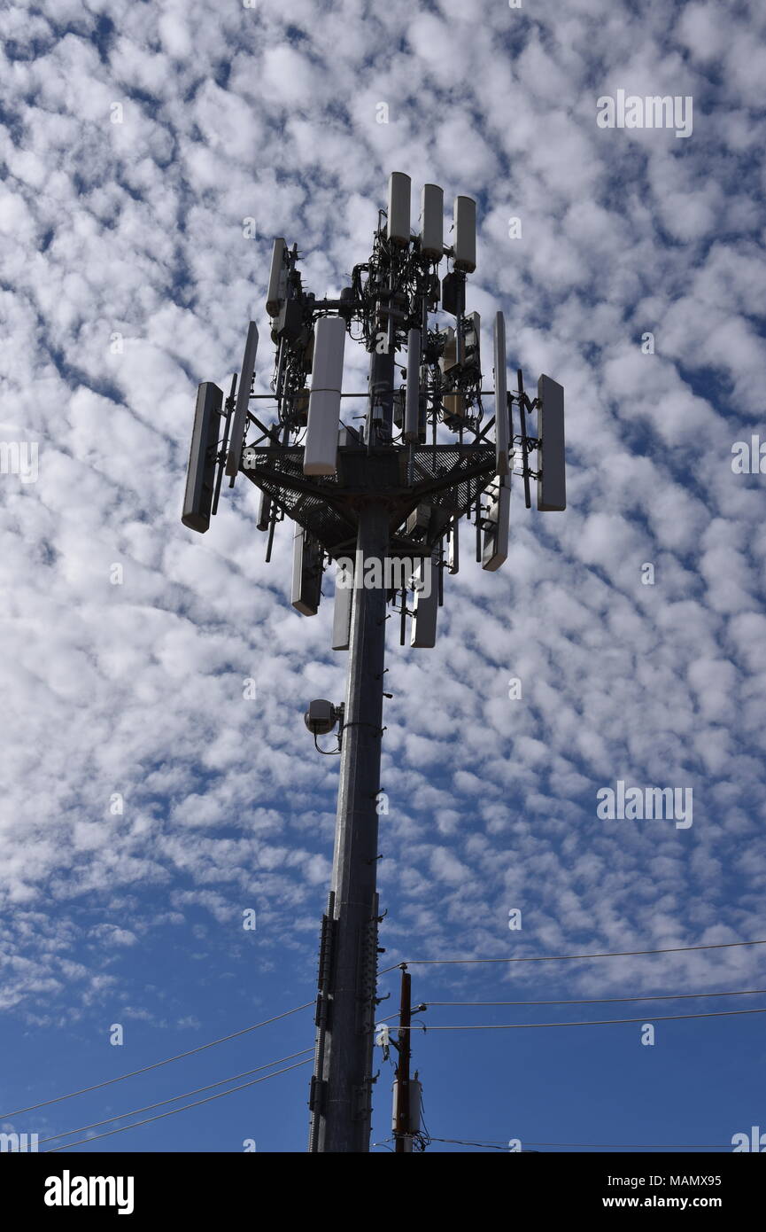 Cell phone tower against a blue sky and clouds Stock Photo - Alamy