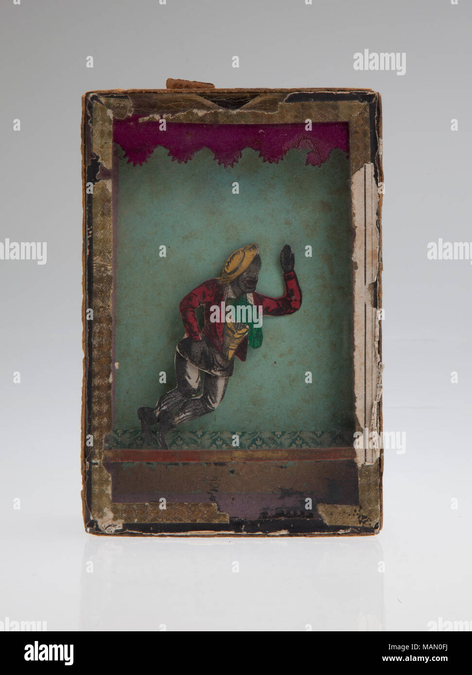 Sand automata toy featuring an African American man dancing. The toy ...