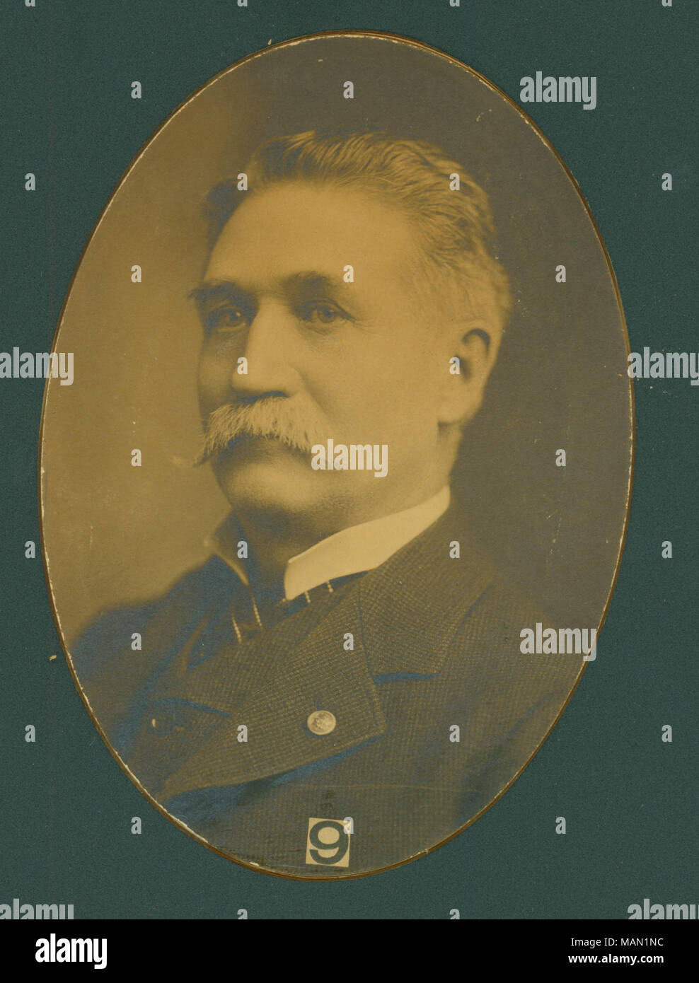 Formal bust portrait of M. R. Udell wearing a suit and striped tie ...