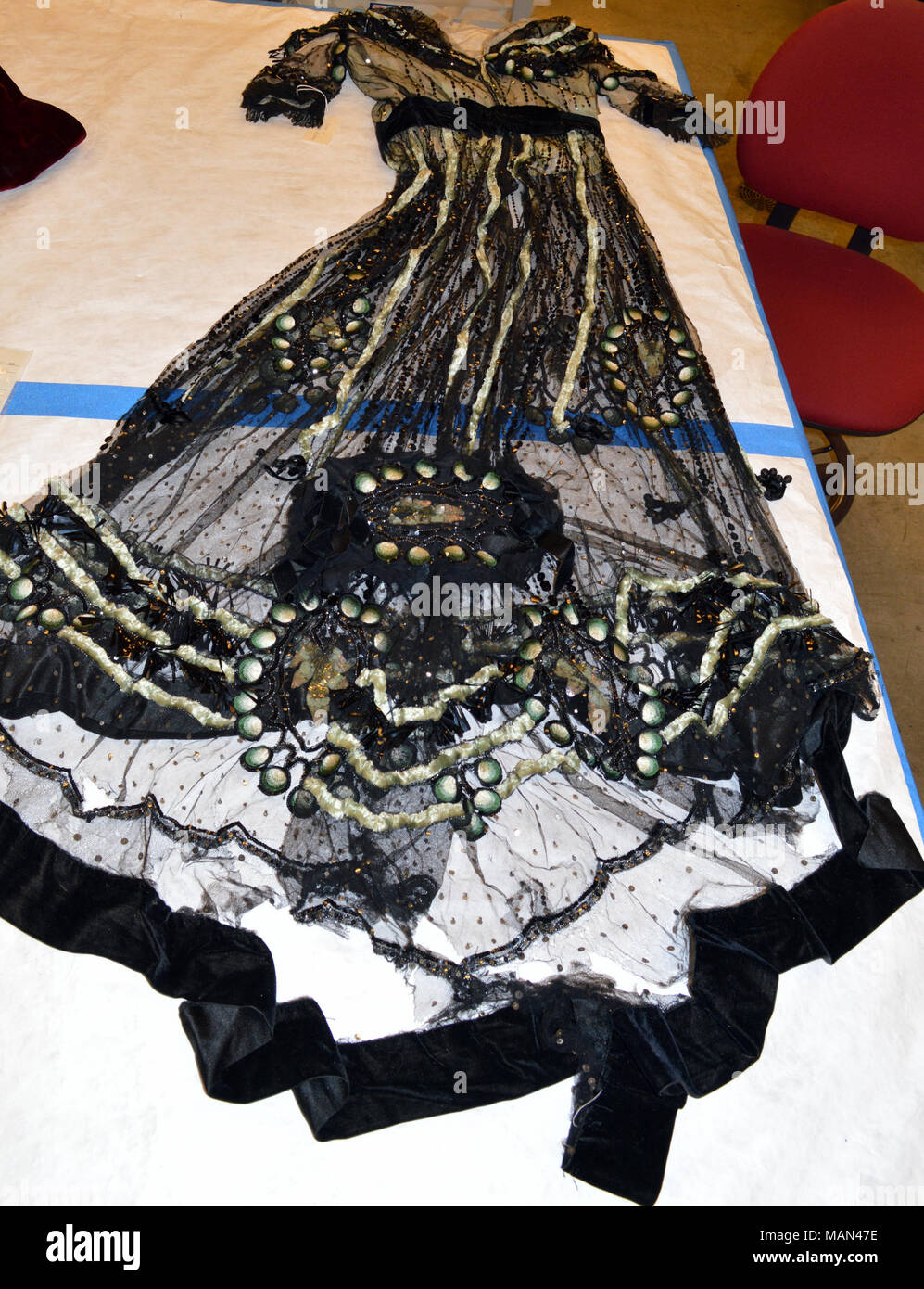 Black net dress with green embroidered disks and sequins. Title: Black ...