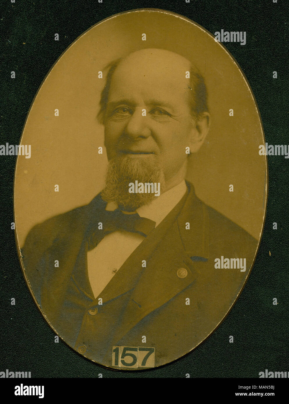 Formal bust portrait of W. H. Simpkins, smiling slightly, wearing a ...