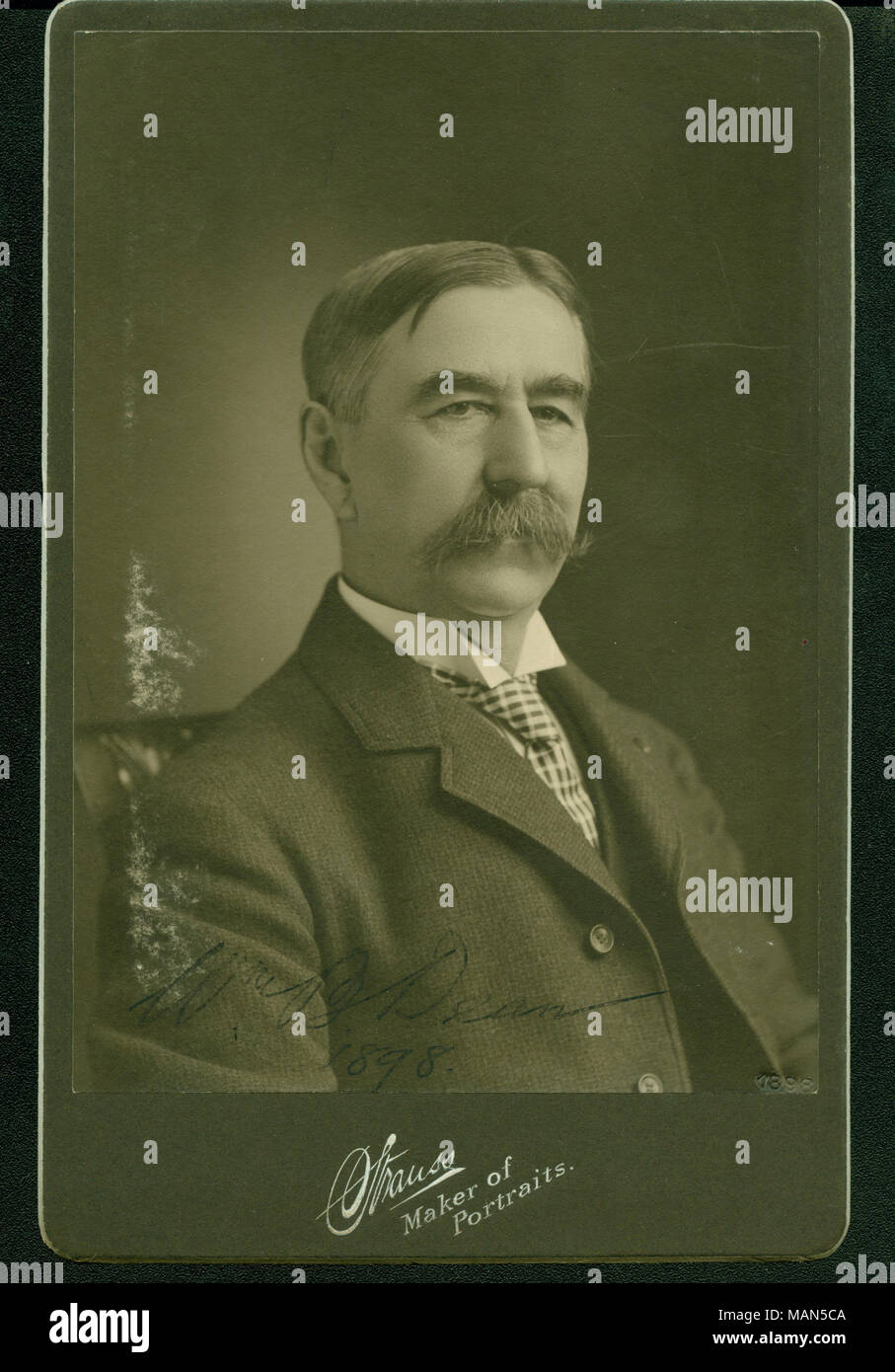 Formal bust portrait of William B. Dean wearing a suit and patterned ...
