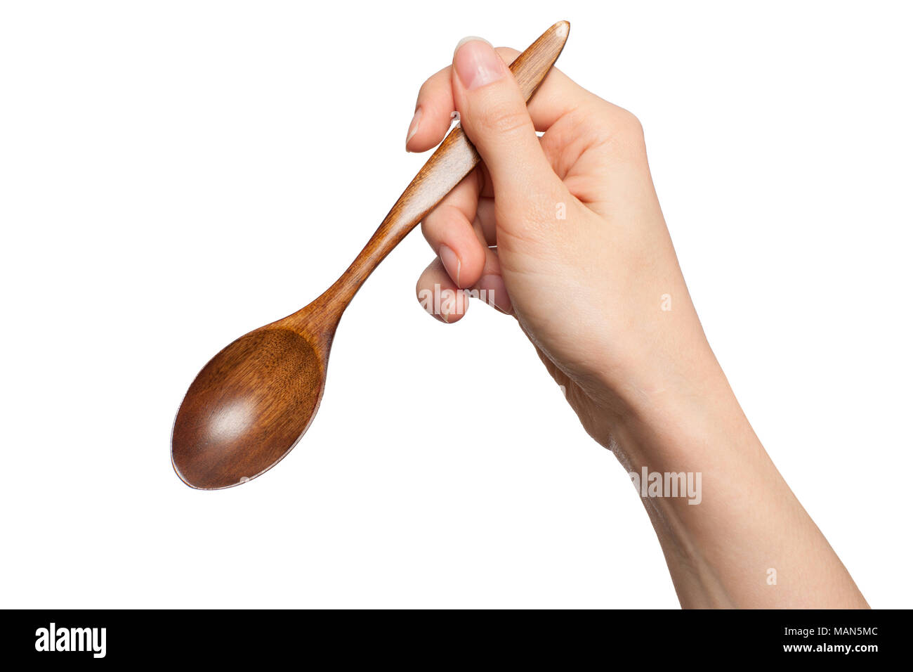 brown wood spoon in hand isolated on white background Stock Photo - Alamy