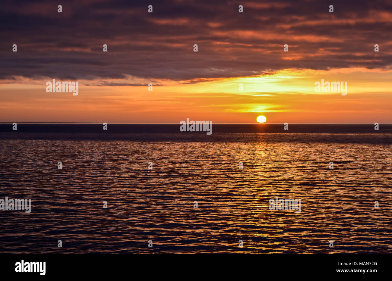 Beautiful sunset over the quiet calm sea Stock Photo - Alamy