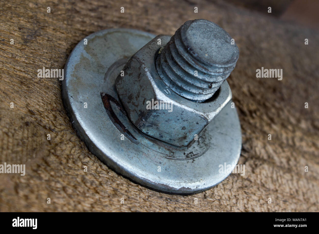 Metal anchoring wooden beams, bolt and nut Stock Photo - Alamy