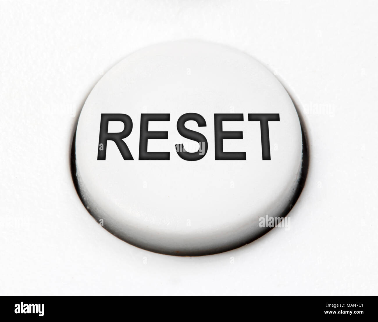A white round button switch for reset close up. Control mechanical key ...