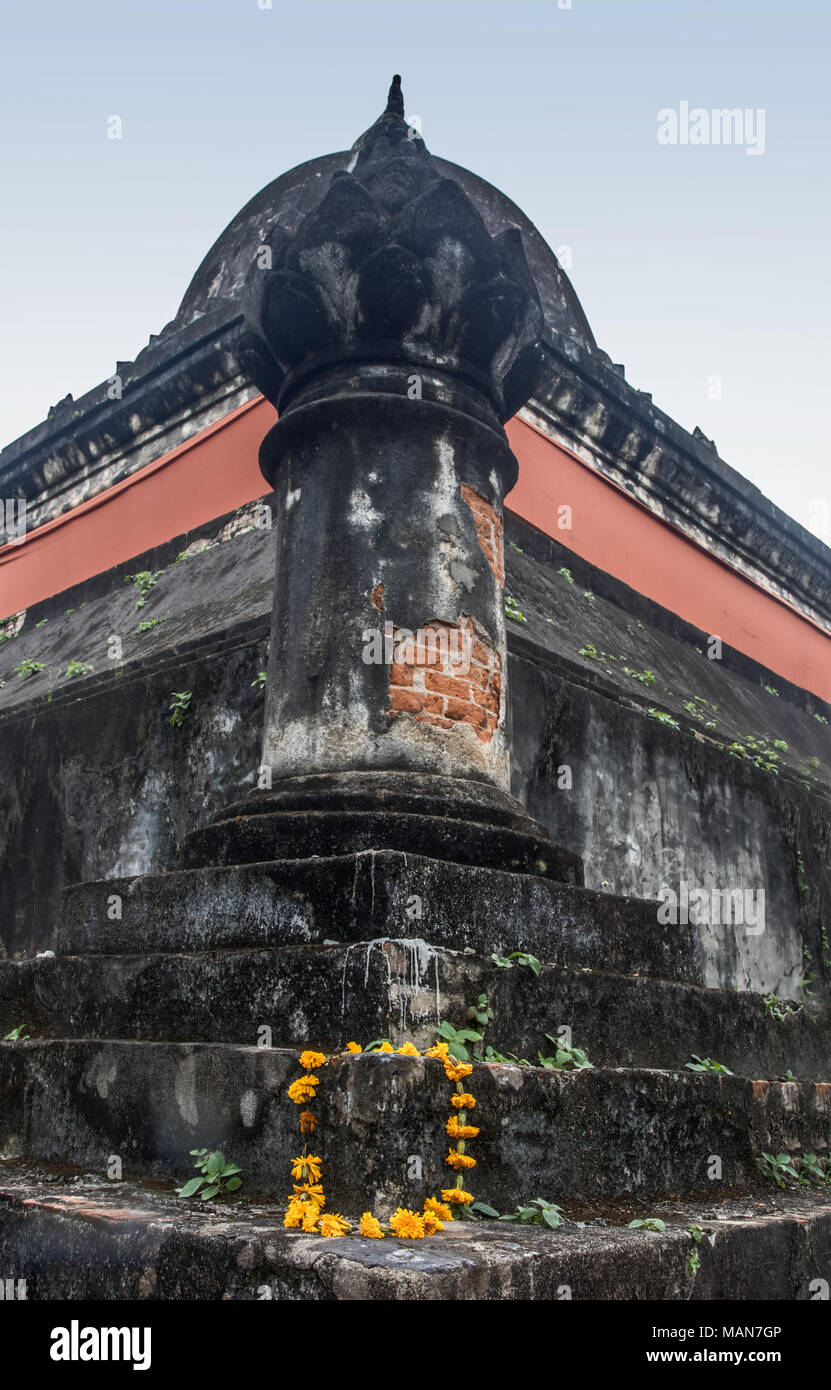a ritual wreath of yellow flowers on a sacral building in a Buddhist ...