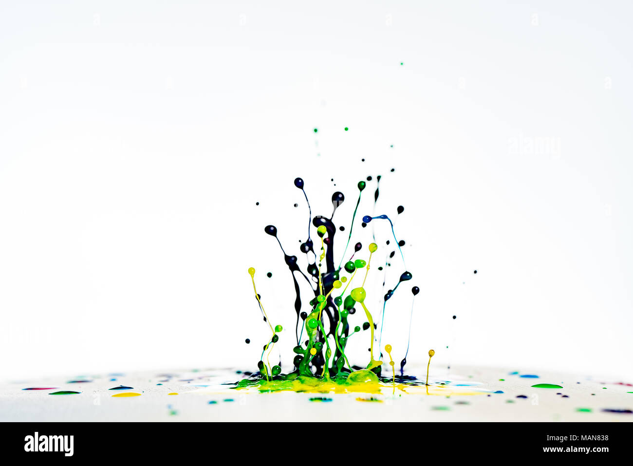 color dancing splashes of paint on a white background Stock Photo - Alamy