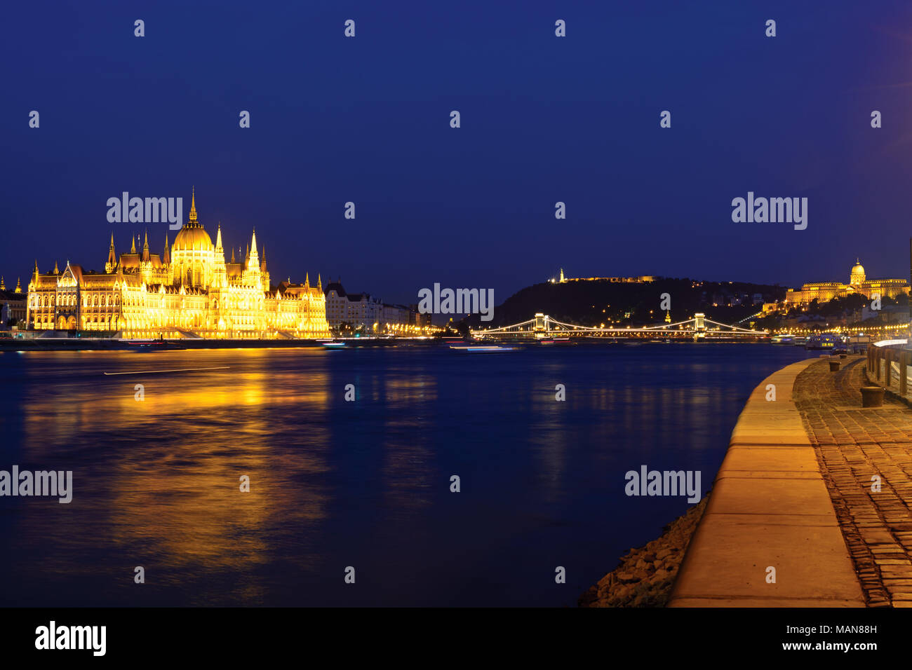 Danube river, stone river bank, Parliament building at night. Budapest ...