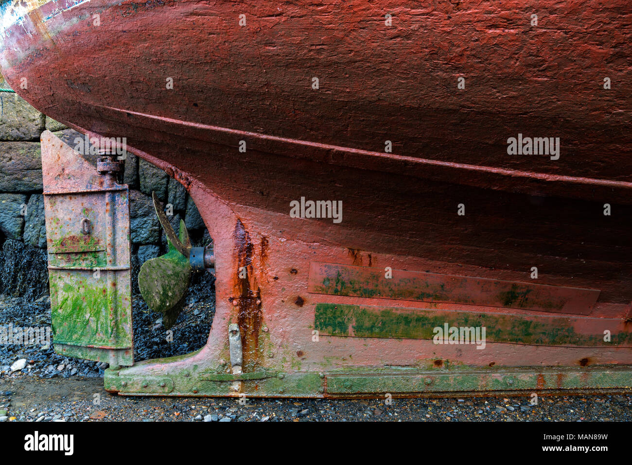 an old cornish fishing trawler hull, rudder and propellor high and dry ...