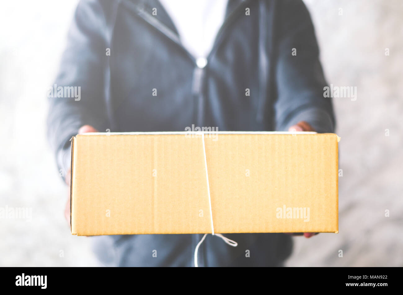 delivery man carrying a parcel box Stock Photo - Alamy