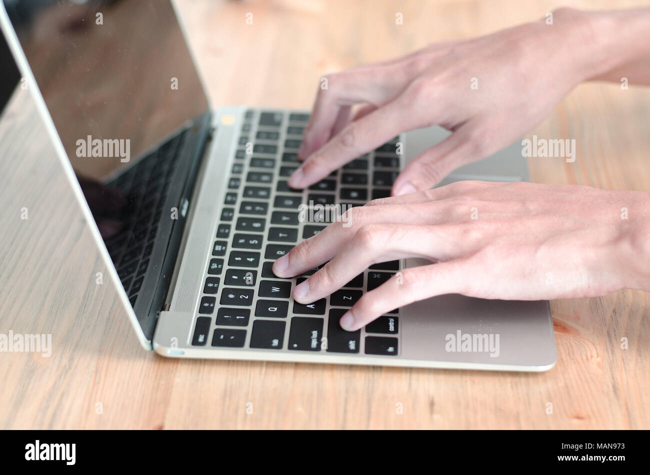 Female hand holding keyboard while working on computer Stock Photo - Alamy