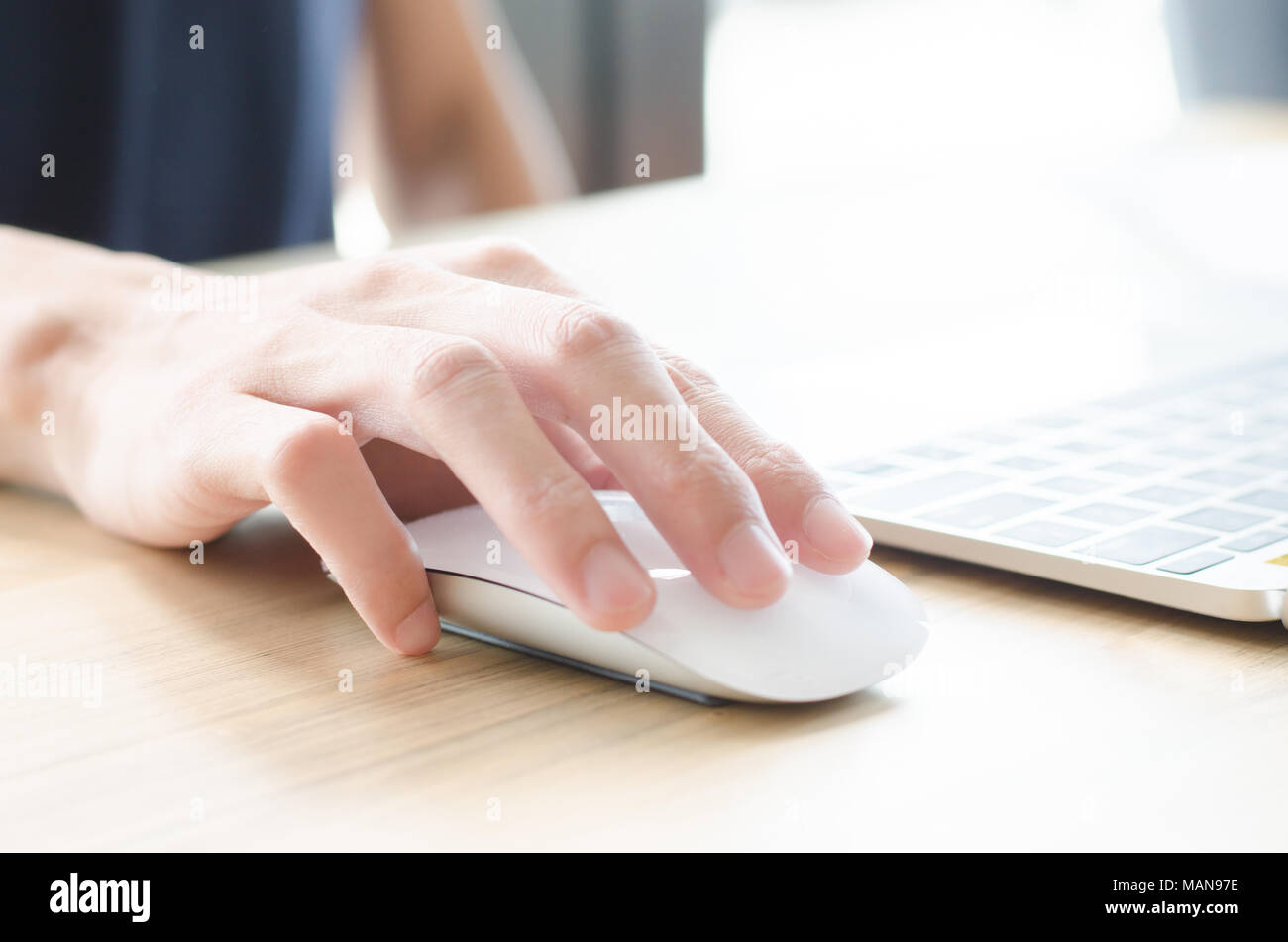 Female hand holding mouse while working on computer Stock Photo - Alamy